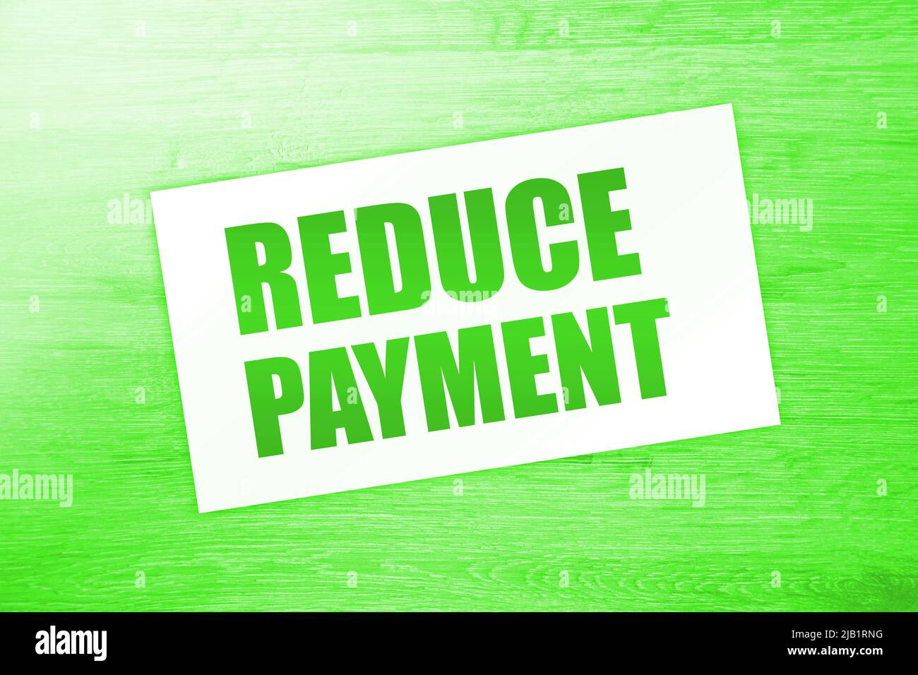 Reduce payment text on card on wooden background. business concept ...