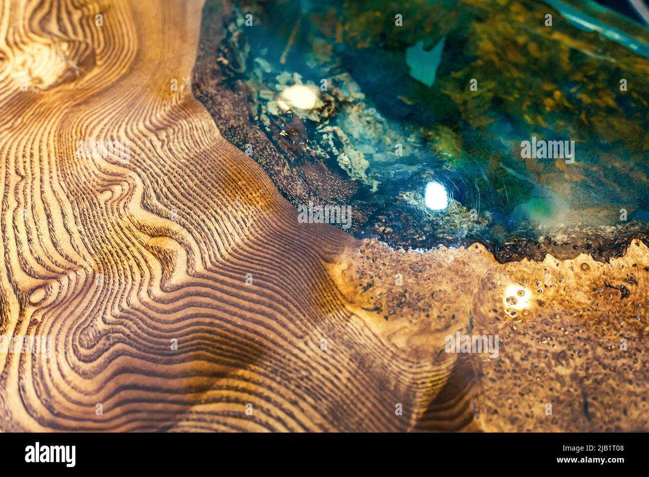 Epoxy resin table with transparent inserts and wooden base Stock Photo ...