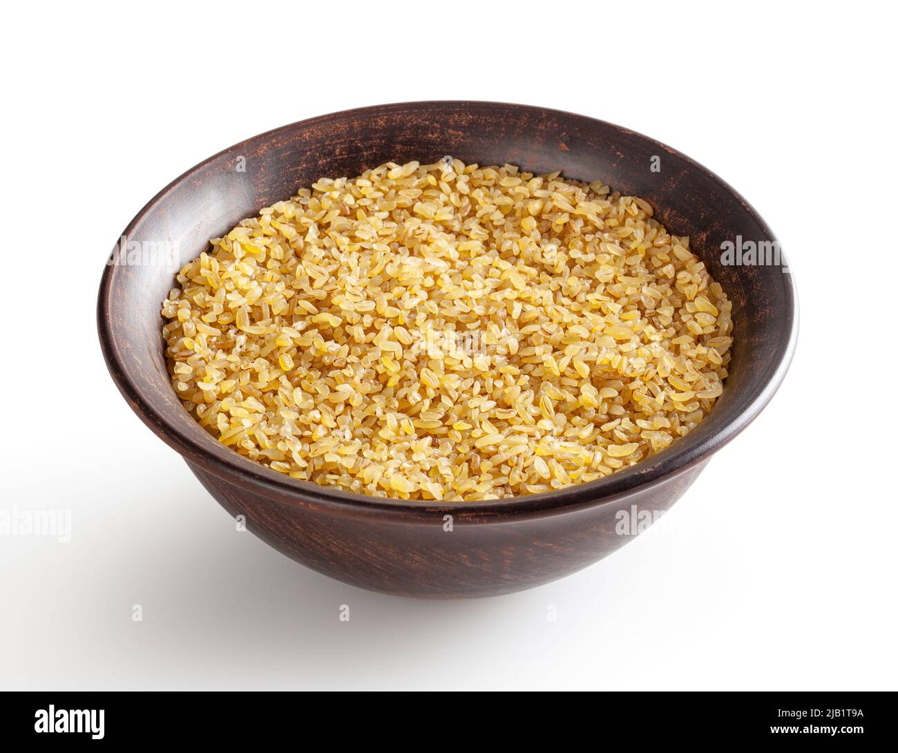 Uncooked bulgur in ceramic bowl isolated on white background with ...