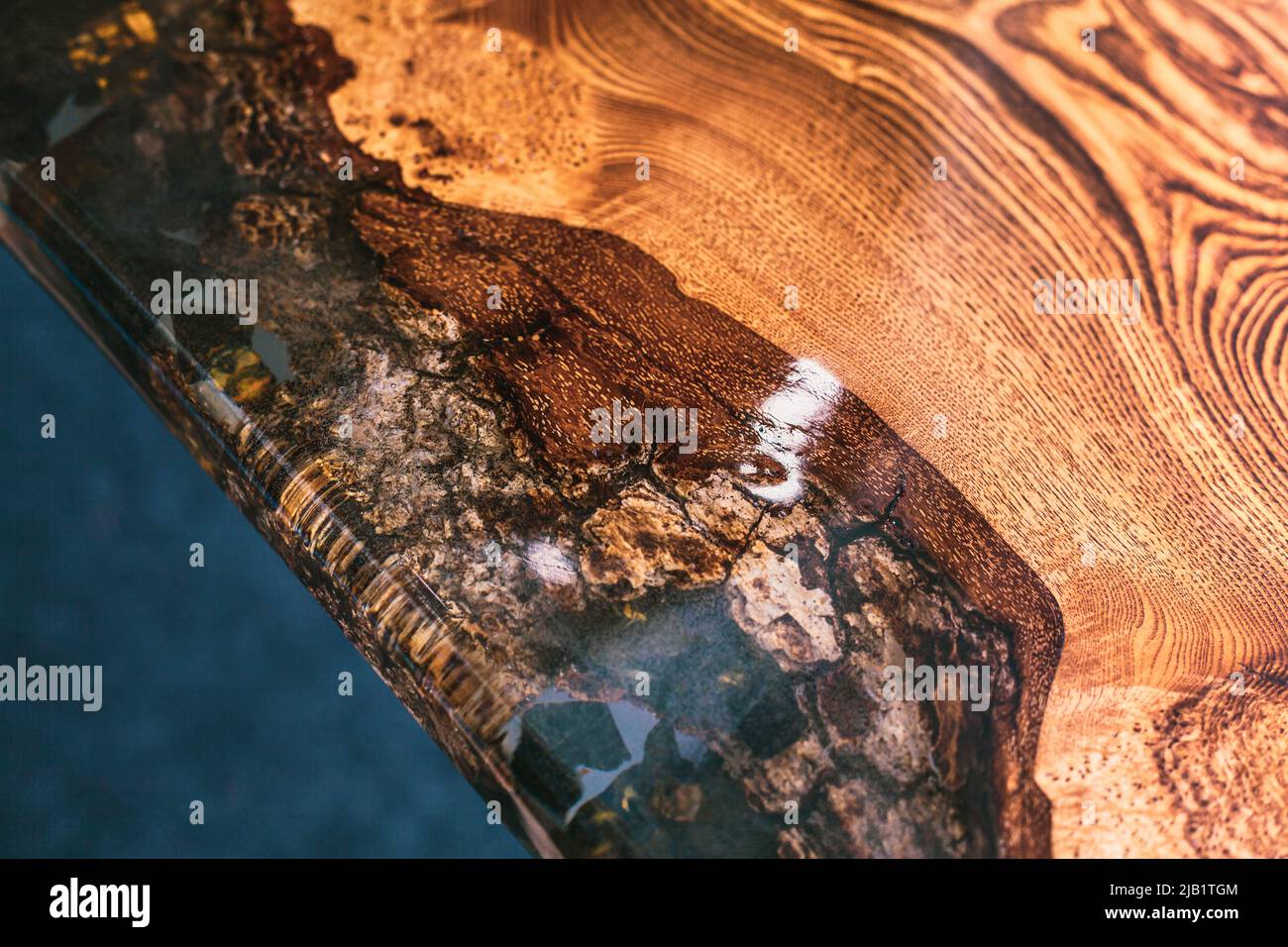 natural stones filled with epoxy resin in a wooden countertop. Handmade ...