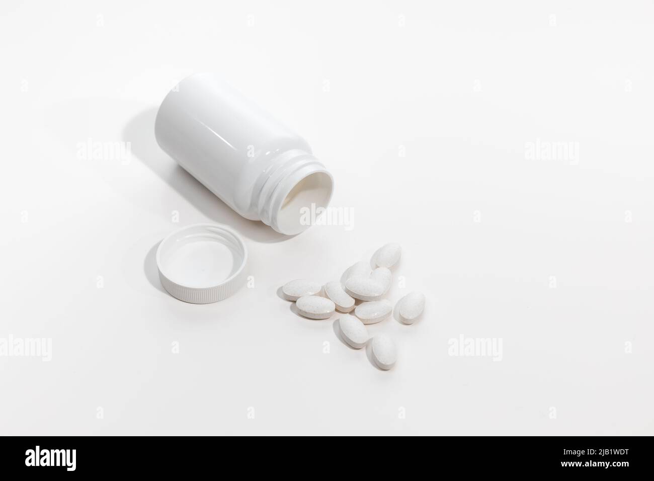assorted white pharmaceutical capsules, pills, tablets, and medication ...