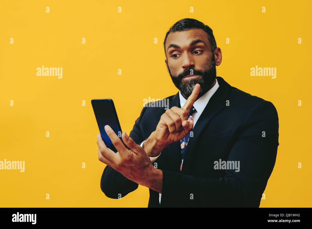 portrait of angry distressed bearded man in suit and tie with ...