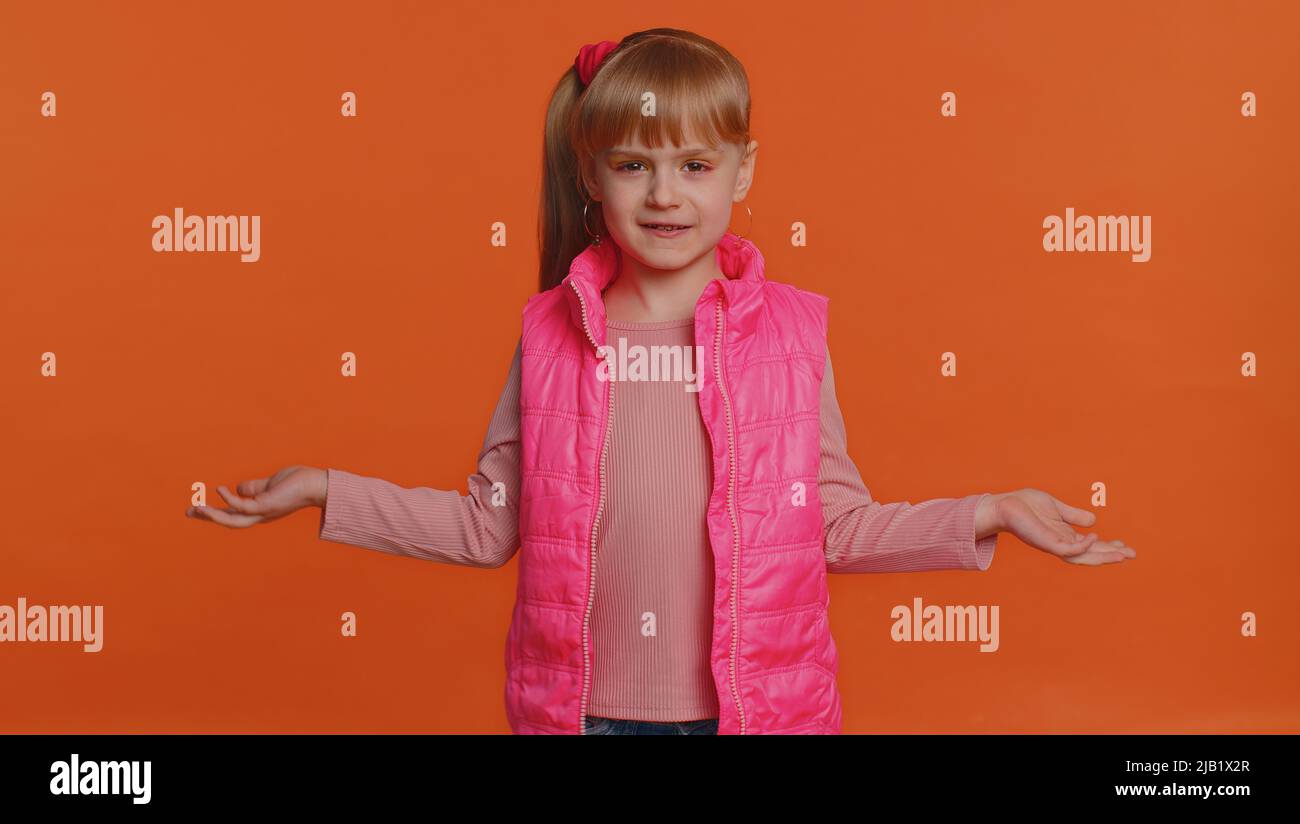 What Why. Sincere irritated little girl raising hands in indignant ...