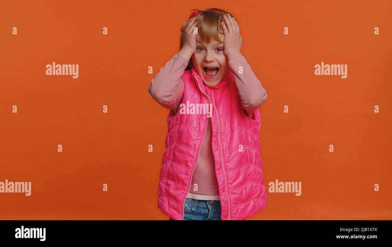 Toddler little girl scared fearful, covering ears with hands, closing ...