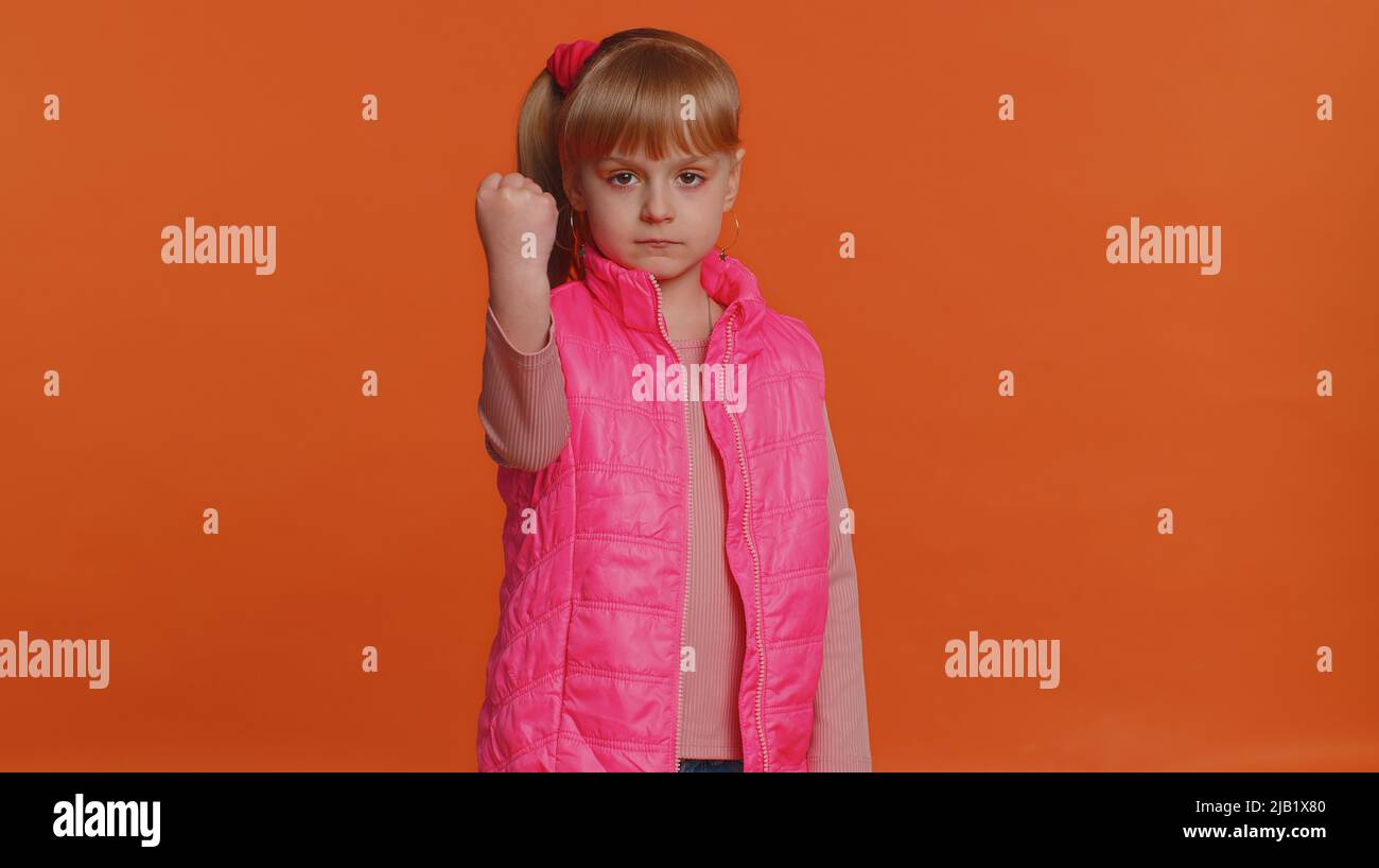 Aggressive angry toddler girl teen kid trying to fight at camera ...