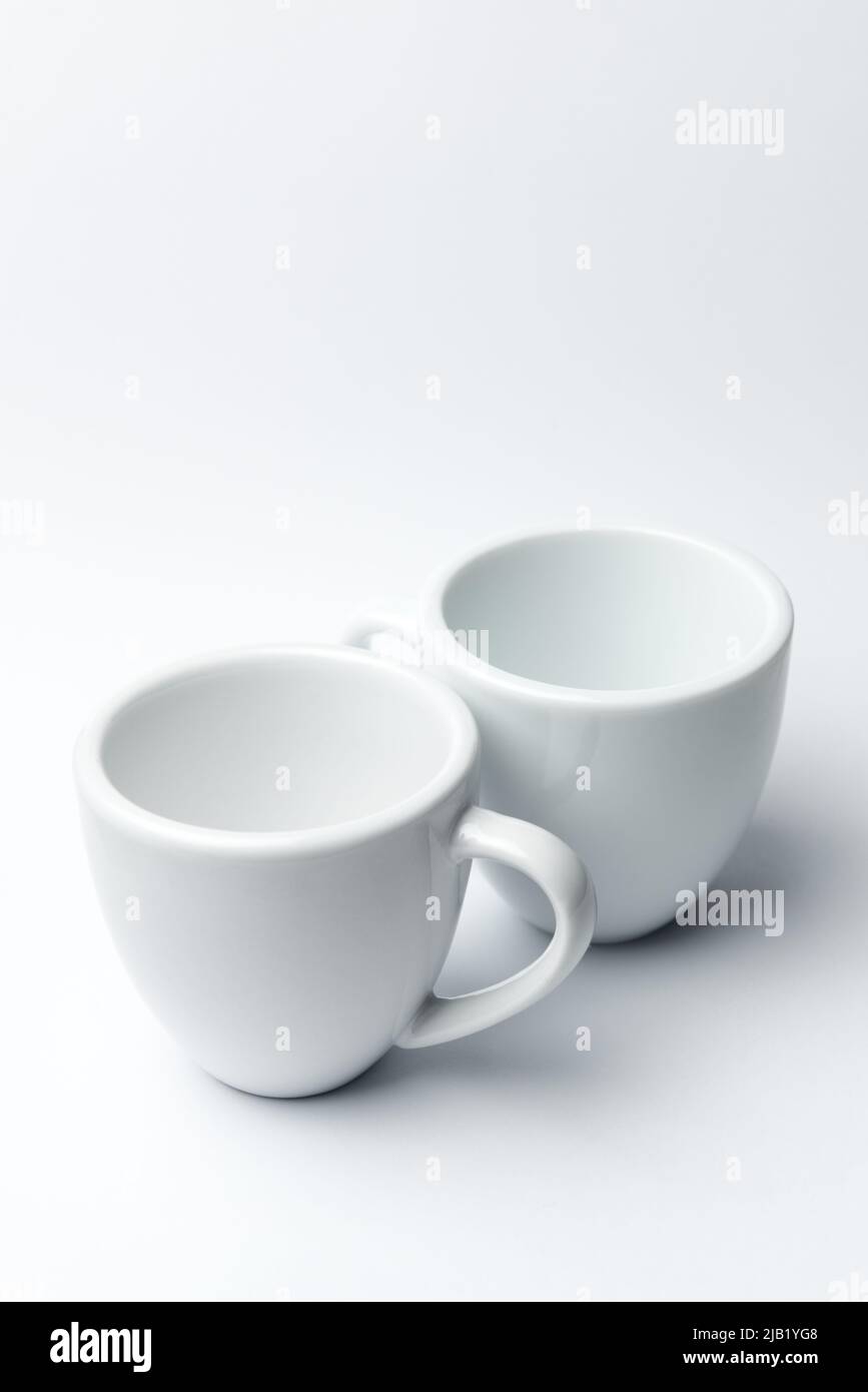 Two empty coffee cups on white background Stock Photo - Alamy