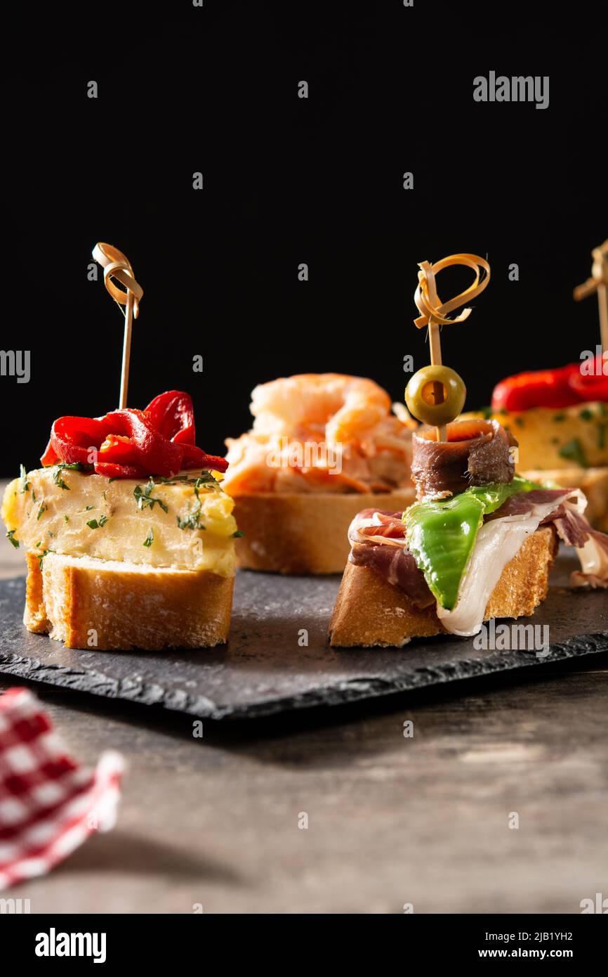 Assortment of Spanish pintxos on wooden table Stock Photo - Alamy