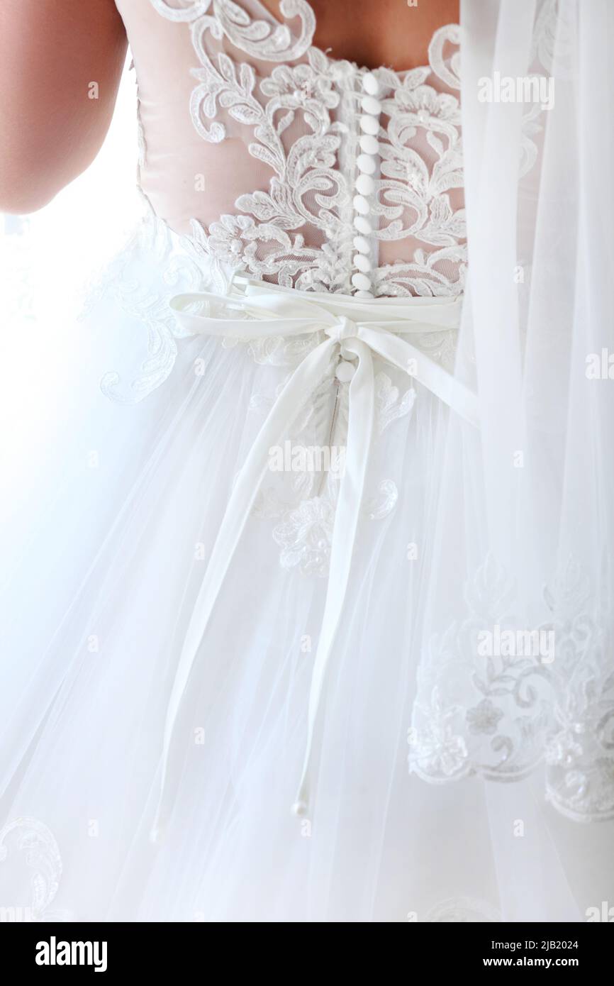 Bride dressing wedding gown Stock Photo - Alamy