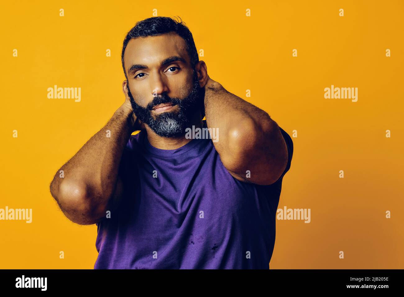 closeup portrait of a handsome sensitive young adult man hands on head ...