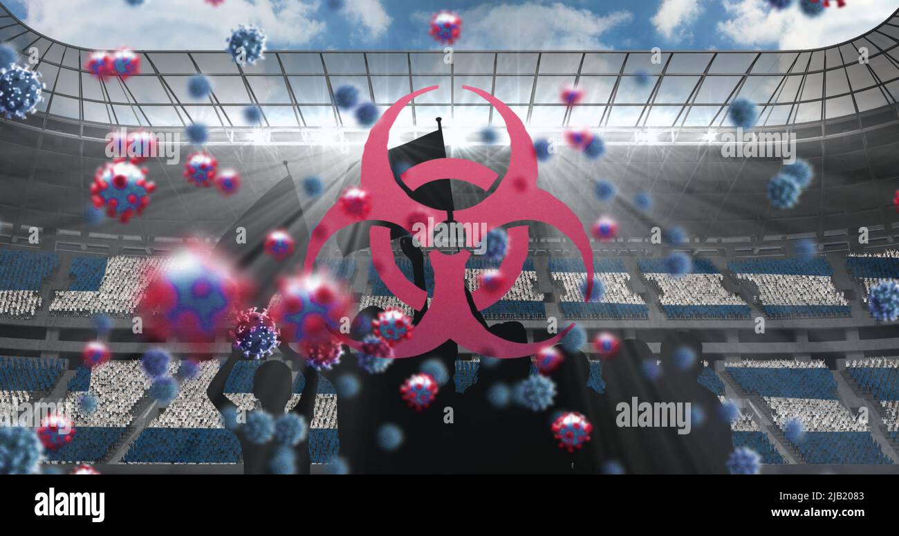 Biohazard symbol and covid-19 cells floating over silhouette of fans ...