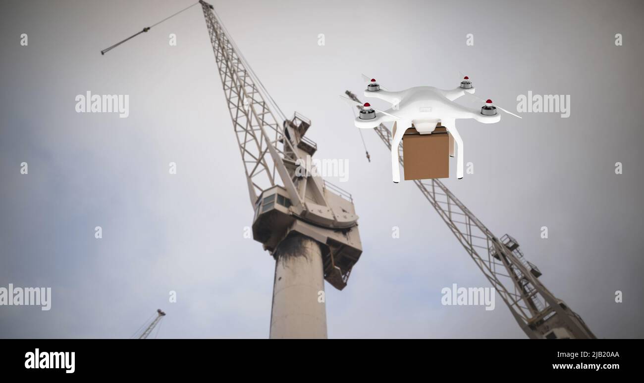 Drone carrying a box and crane Stock Photo - Alamy