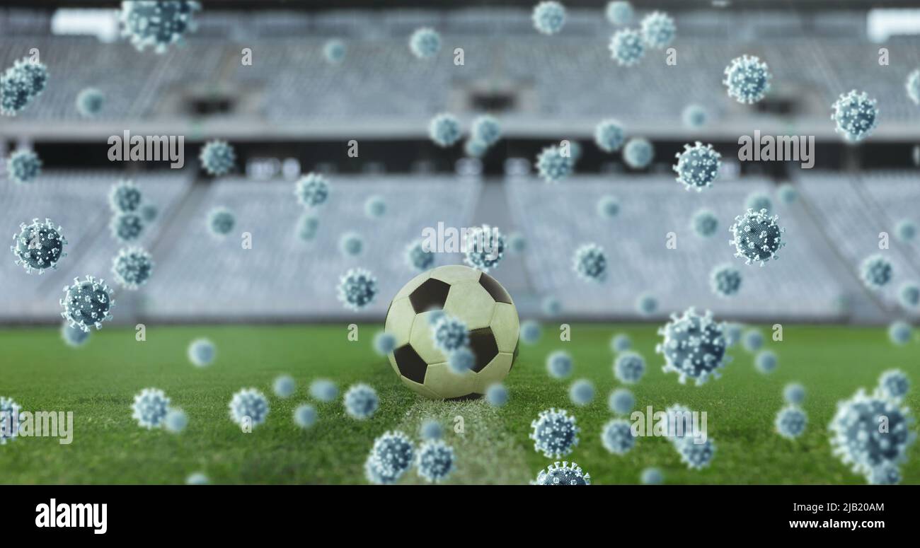 Covid-19 cells against soccer ball in sports stadium Stock Photo - Alamy