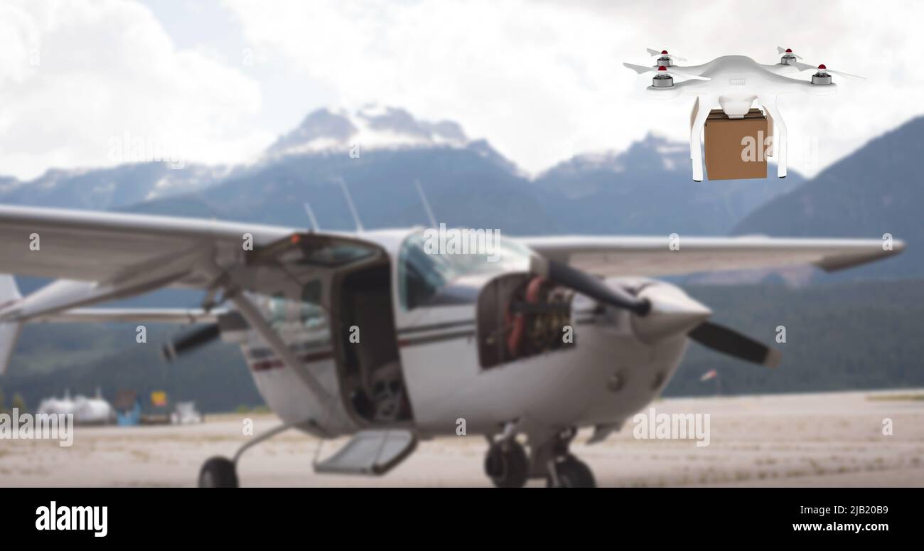 Drone carrying a box in front of an airplane Stock Photo - Alamy