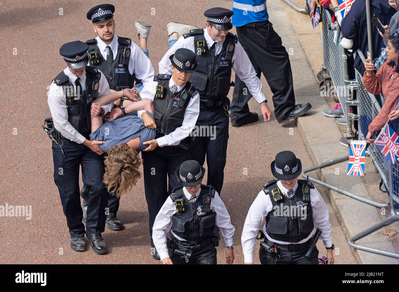Police officers remove people who ran into the path of the royal ...