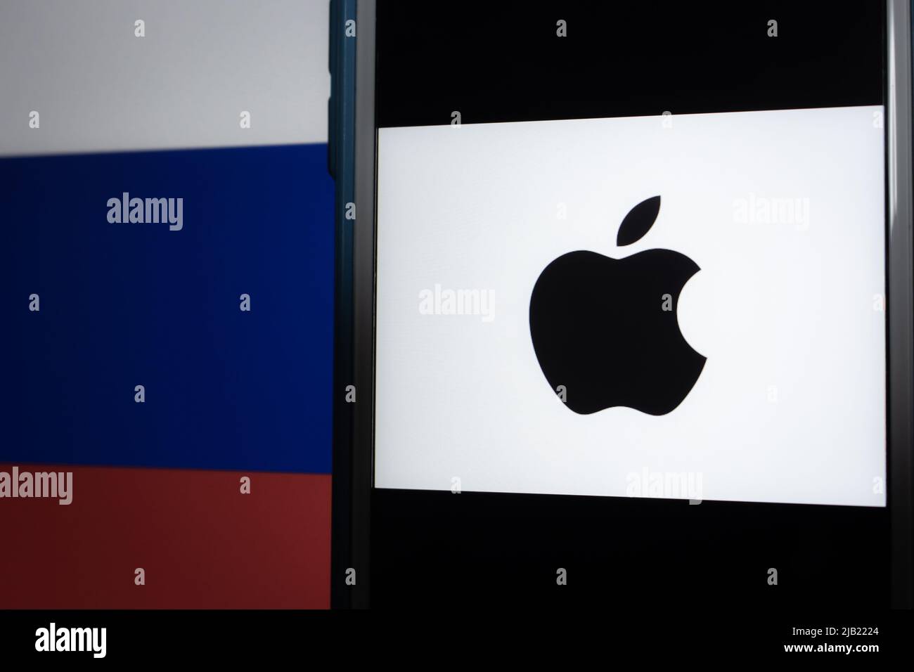 Apple logo on iPhone on the Russian flag in the dark mood. In 2022 Mar ...