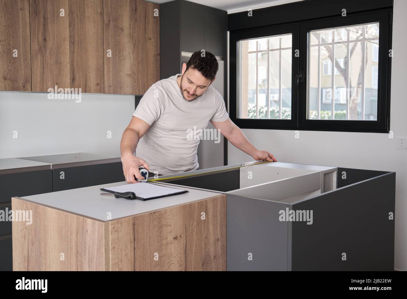 Man using tape to measure cabinet hi-res stock photography and images ...