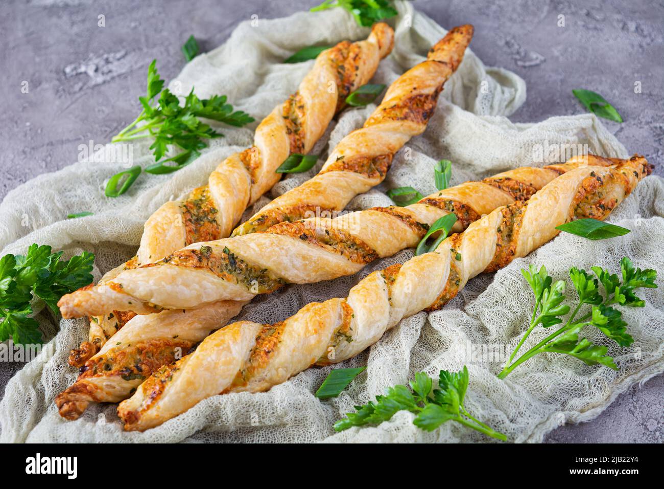 Puff sticks with cheese and herbs. Homemade breadsticks with sauce ...