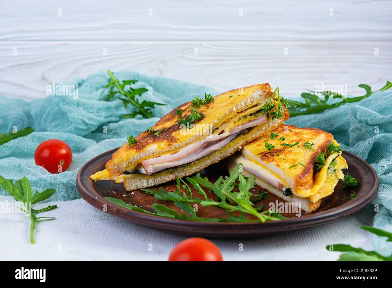 Roasted toast in scrambled eggs with ham, herbs and cheese cheddar ...