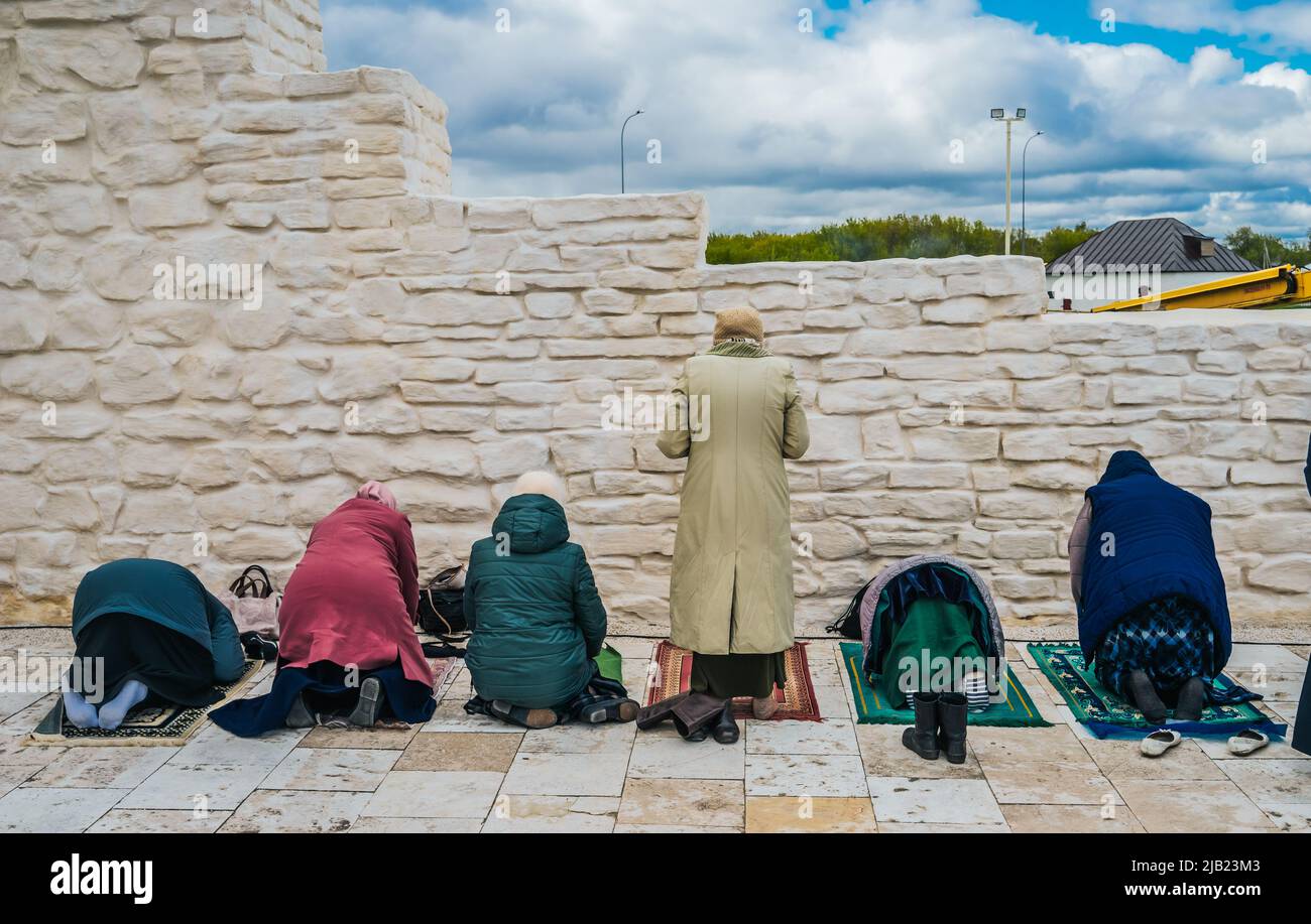 Muslim women pray. Namaz. Women praying on prayer mats against an old ...