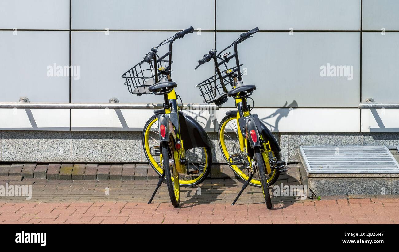 Bike sharing. Two yellow sharing bikes Stock Photo - Alamy