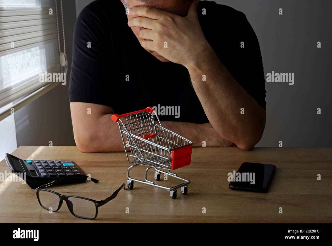 The man thinks about his economic problems. Various office tools and ...