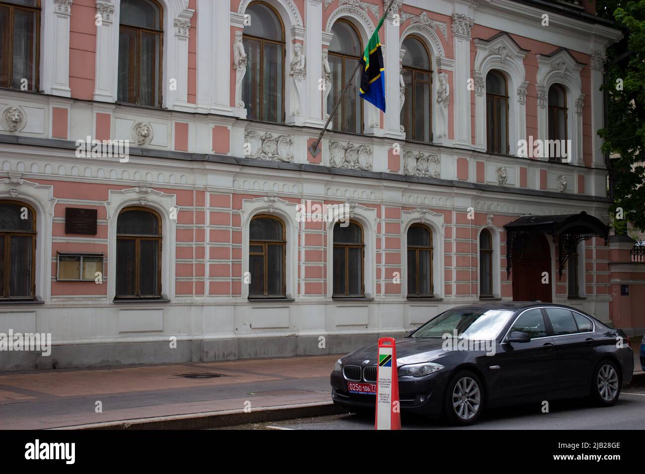 A car with red diplomatic plates is parked in front of the Embassy of ...