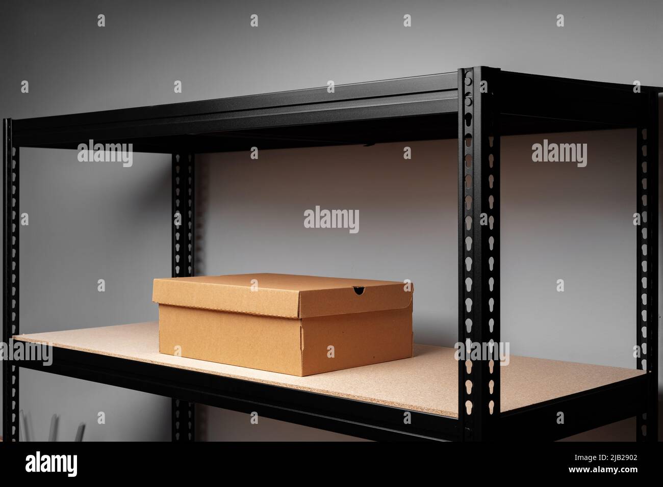 Stand shelf with one packed cardboard box Stock Photo - Alamy