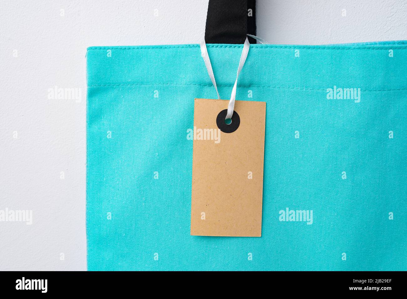 Eco bag for shopping with blank tag on white background Stock Photo - Alamy