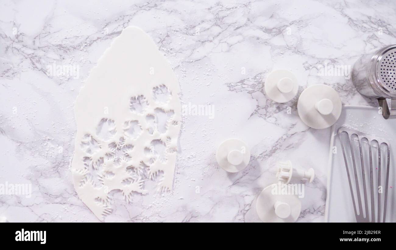 Flat lay. Step by step. Cutting out snowflakes with cookie cutters out ...