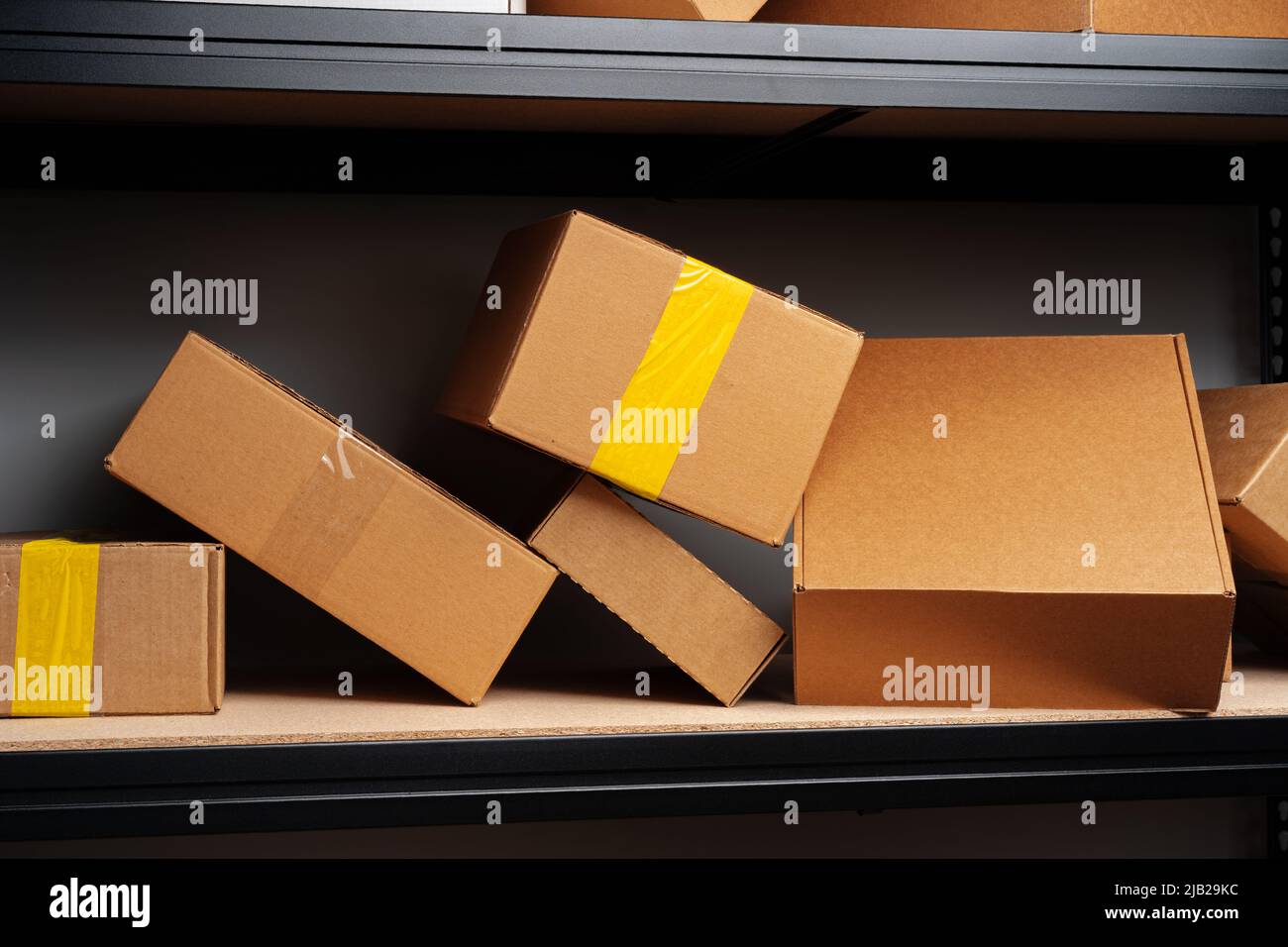Rows of shelves with cardboard boxes in modern warehouse Stock Photo ...