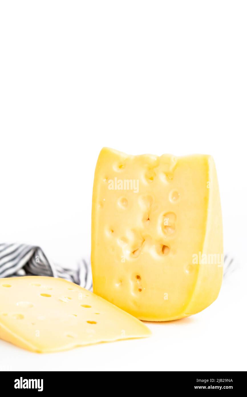 Large slice of semi soft part skim cheese on a white background Stock ...
