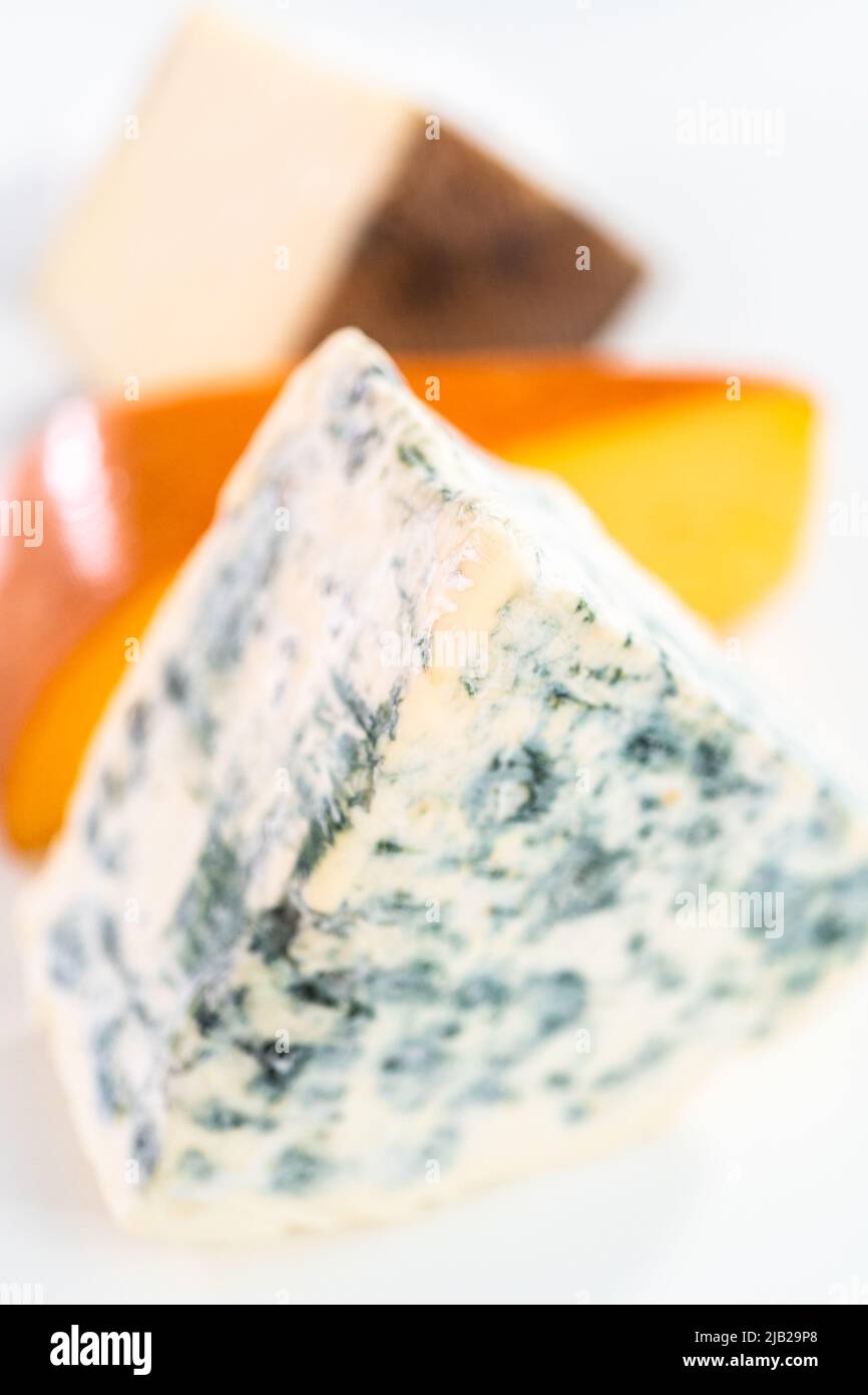 Variety of large wedges gourmet cheese on a white background Stock ...