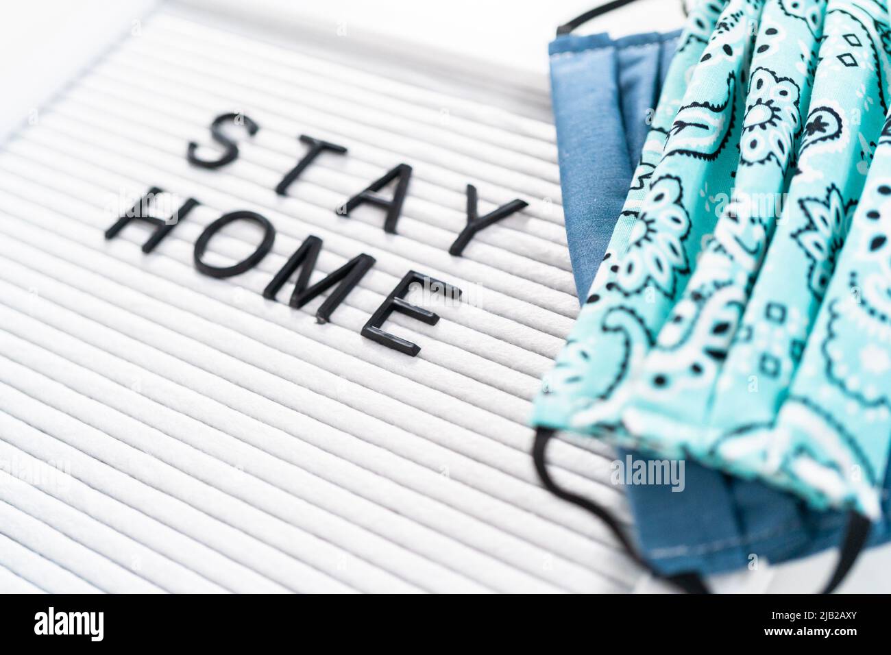 STAY HOME sign on message board with a homemade face mask Stock Photo ...