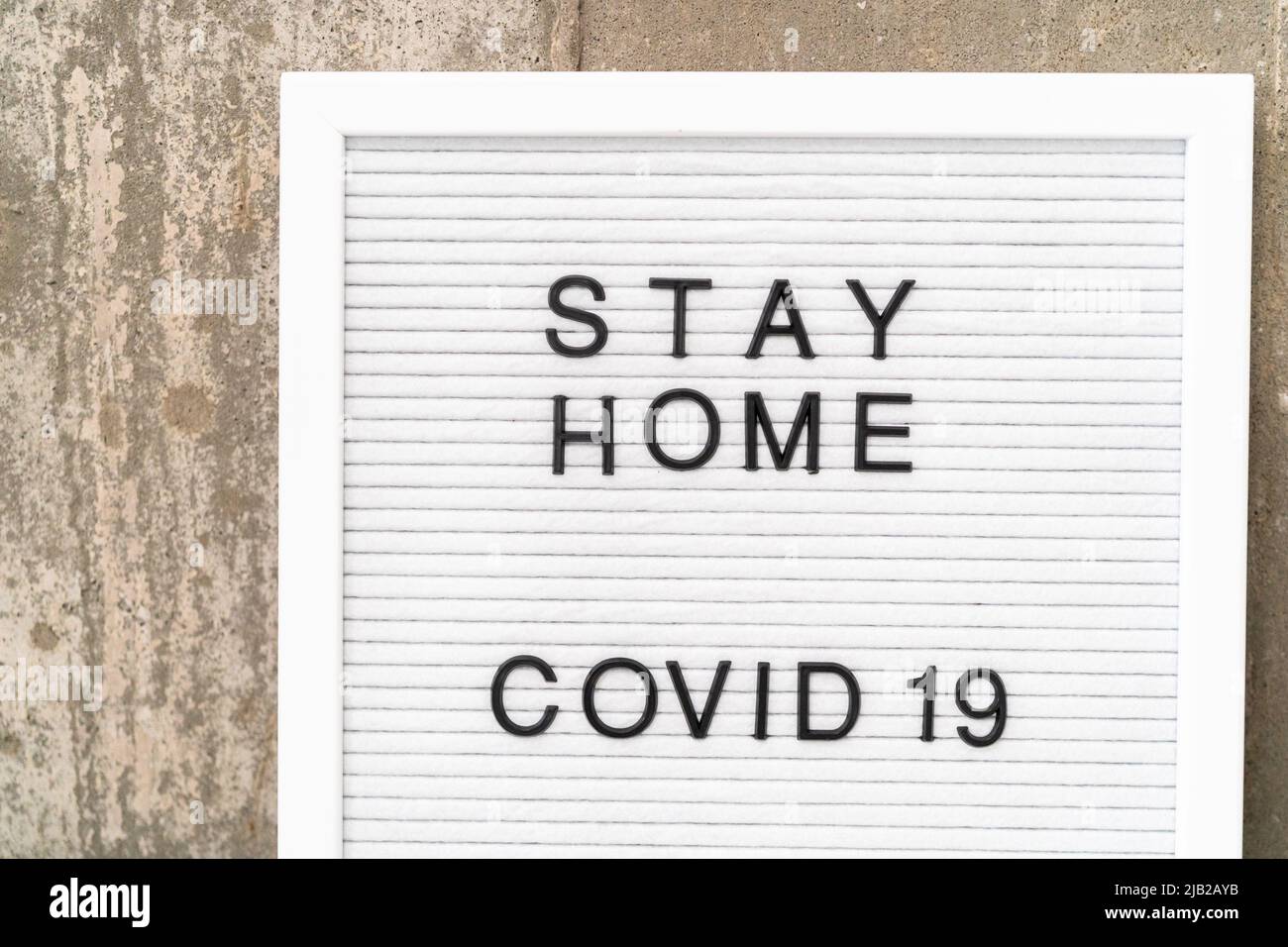 STAY HOME and COVID-19 sign on message board Stock Photo - Alamy