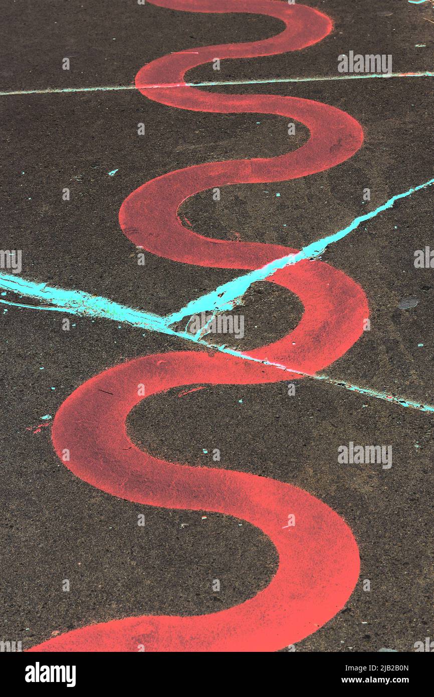 Squiggly wavy and curvy line painted on the concrete sidewalk in a ...
