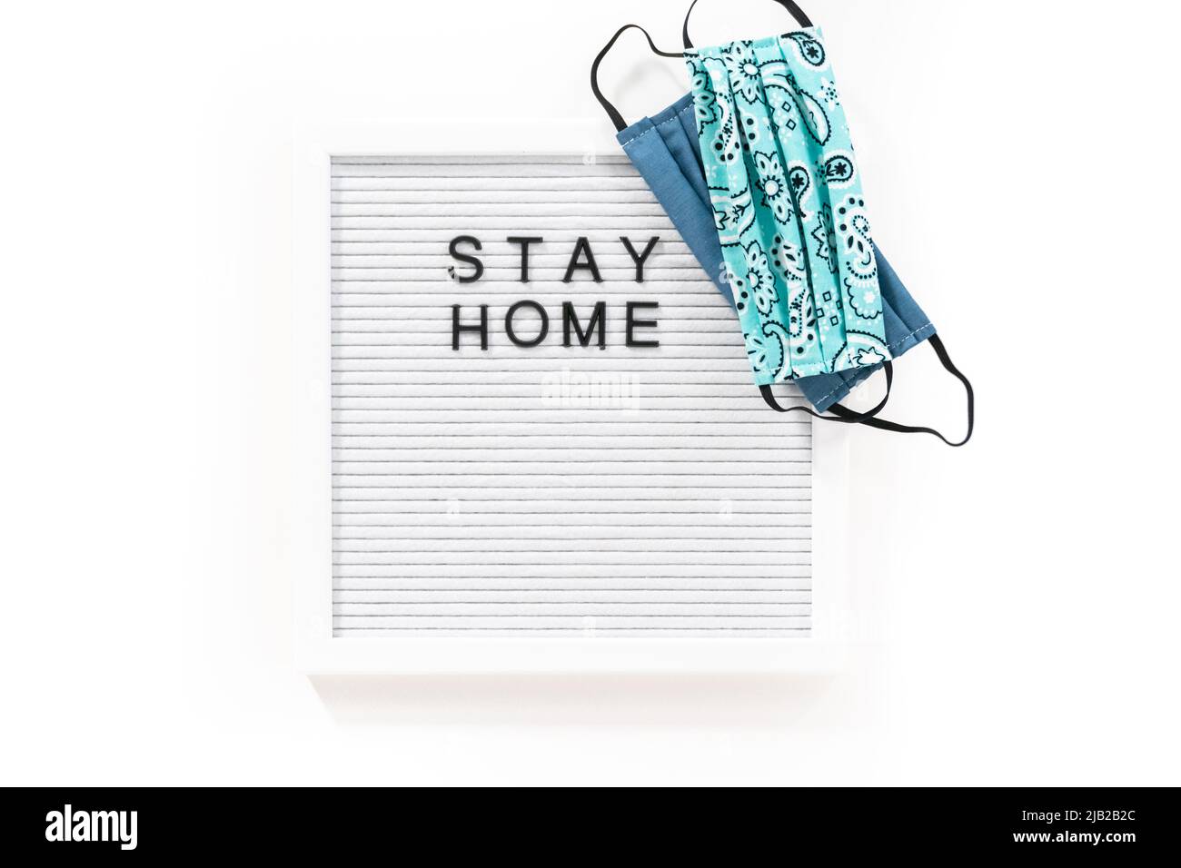 STAY HOME sign on message board with a homemade face mask Stock Photo ...