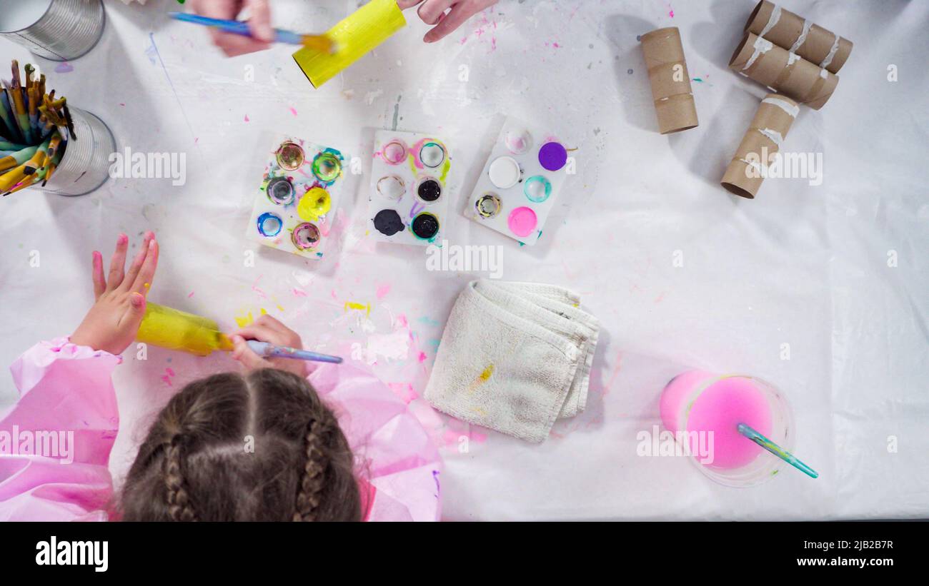 Flat lay. Kids papercraft. Painting empty toilet paper rolls with ...