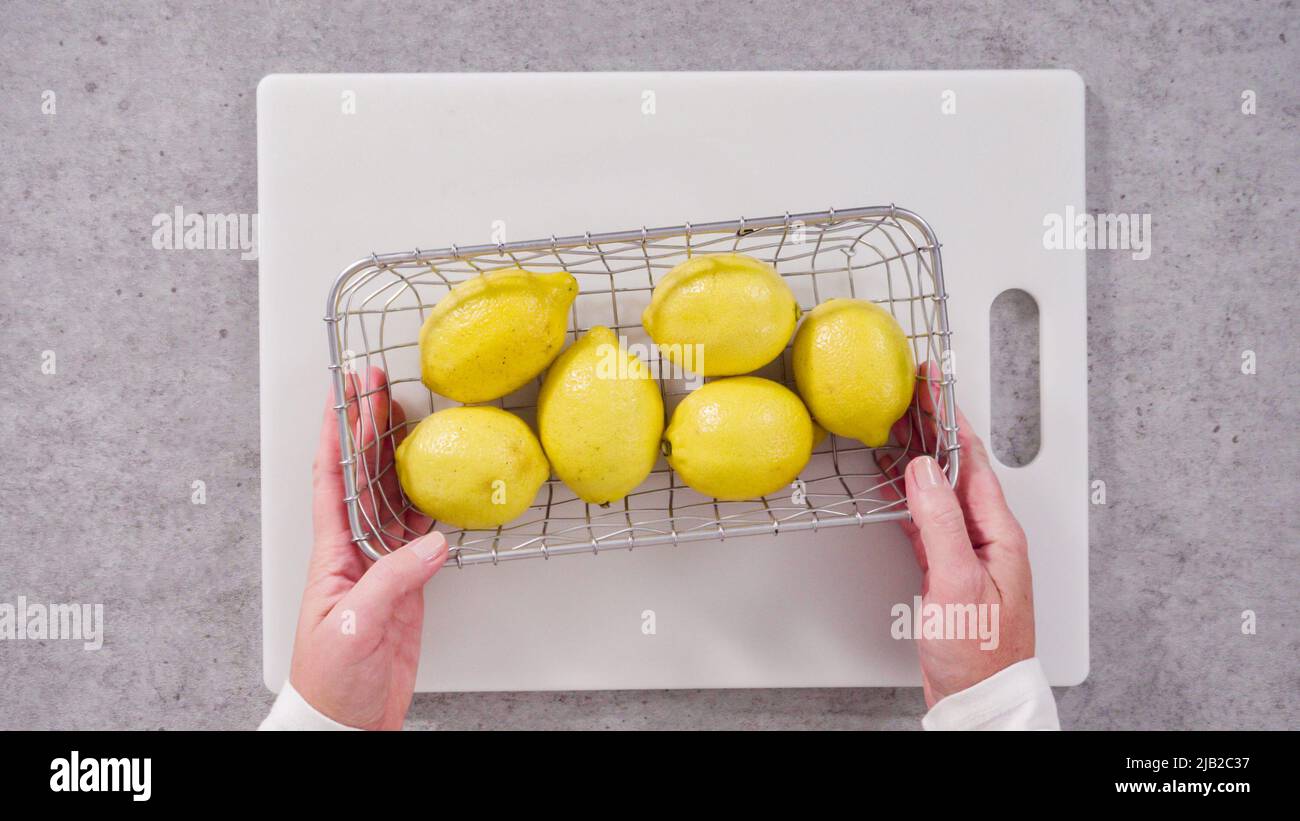 Flat lay. Whole lemons in a wired basket to bake a lemon pound cake ...