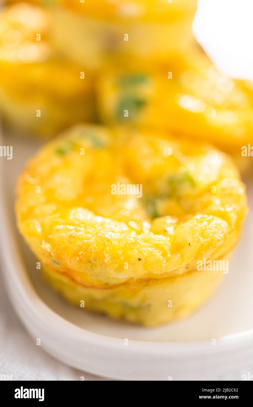 Bacon and cheese egg muffin on a white serving plate Stock Photo - Alamy
