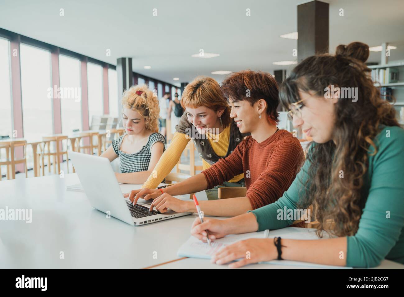 Diverse students working on project together Stock Photo - Alamy
