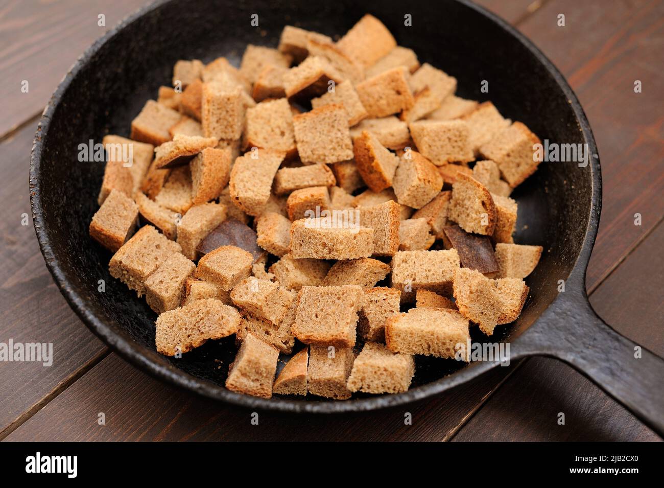 Roasted rye bread in black cast iron pan closeup Stock Photo - Alamy