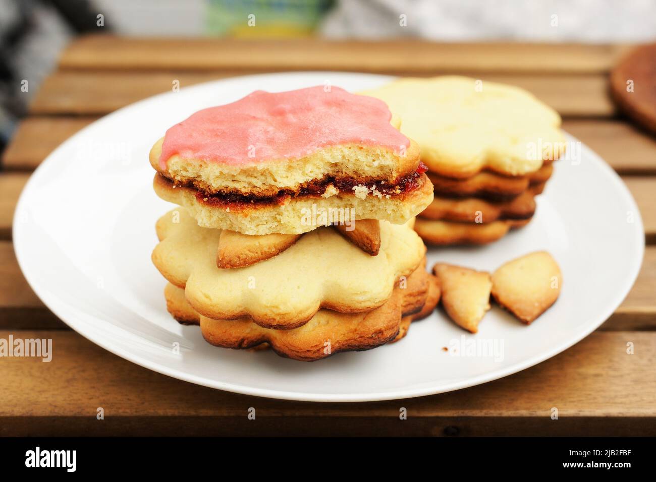 Soviet Russian shortbread cookies with pink icing and jam close up ...