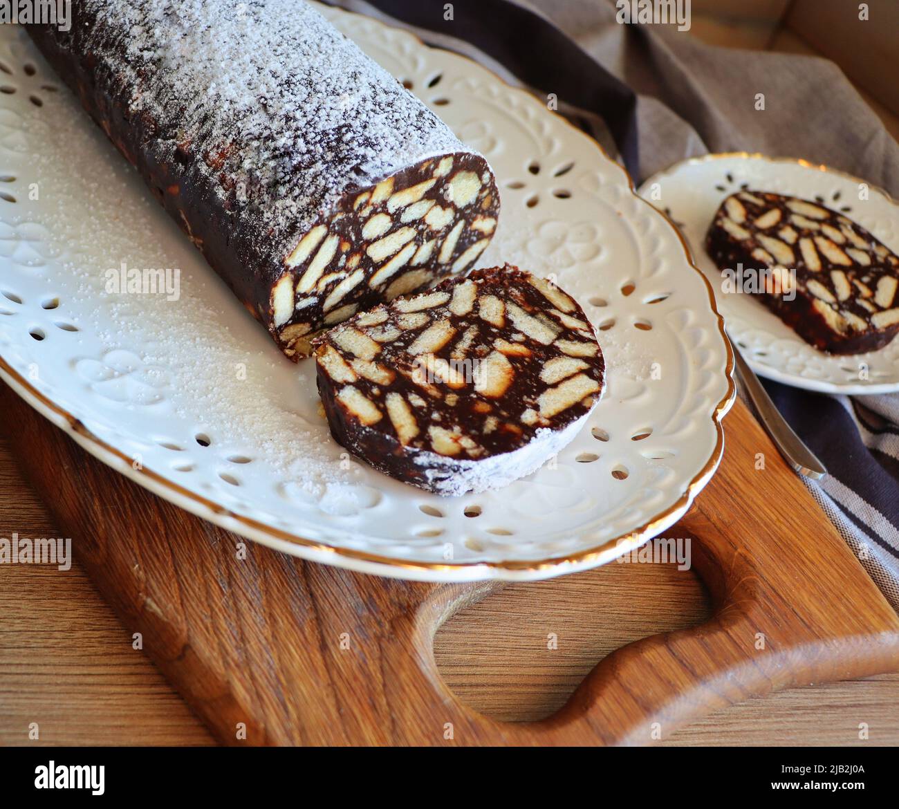 Lazy cake or mosaic cake . Homemade no bake chocolate biscuit cake on a ...