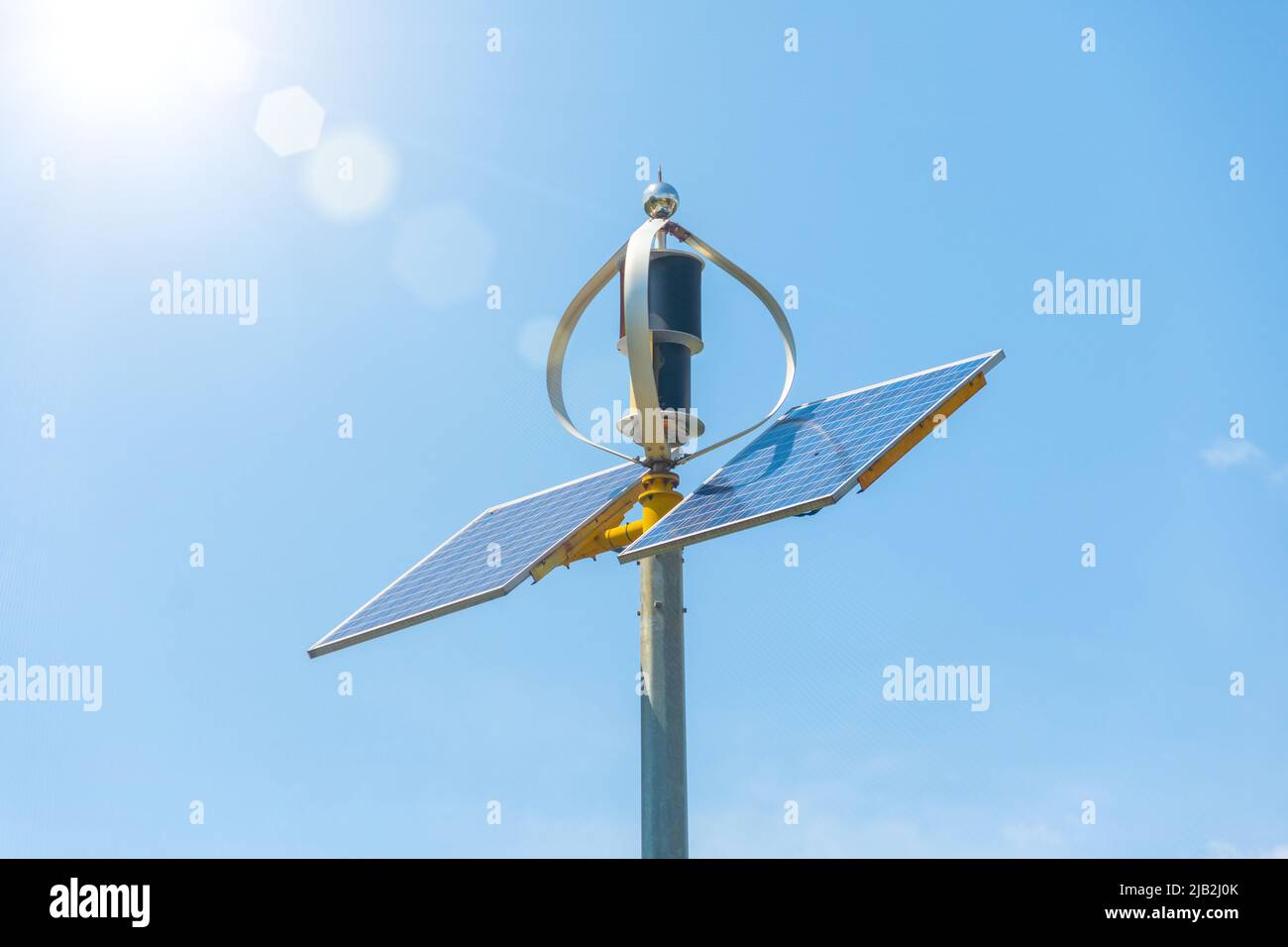 Solar panel and wind propeller mounted on a pole in the city for local ...