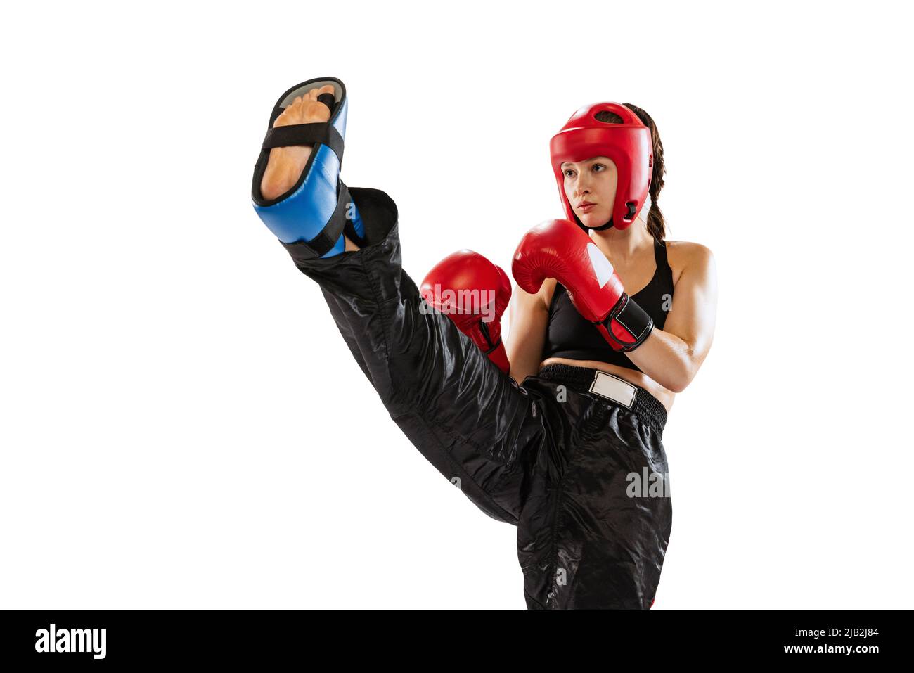 Close-up female boxer in boxing gloves and helmet training isolated on ...