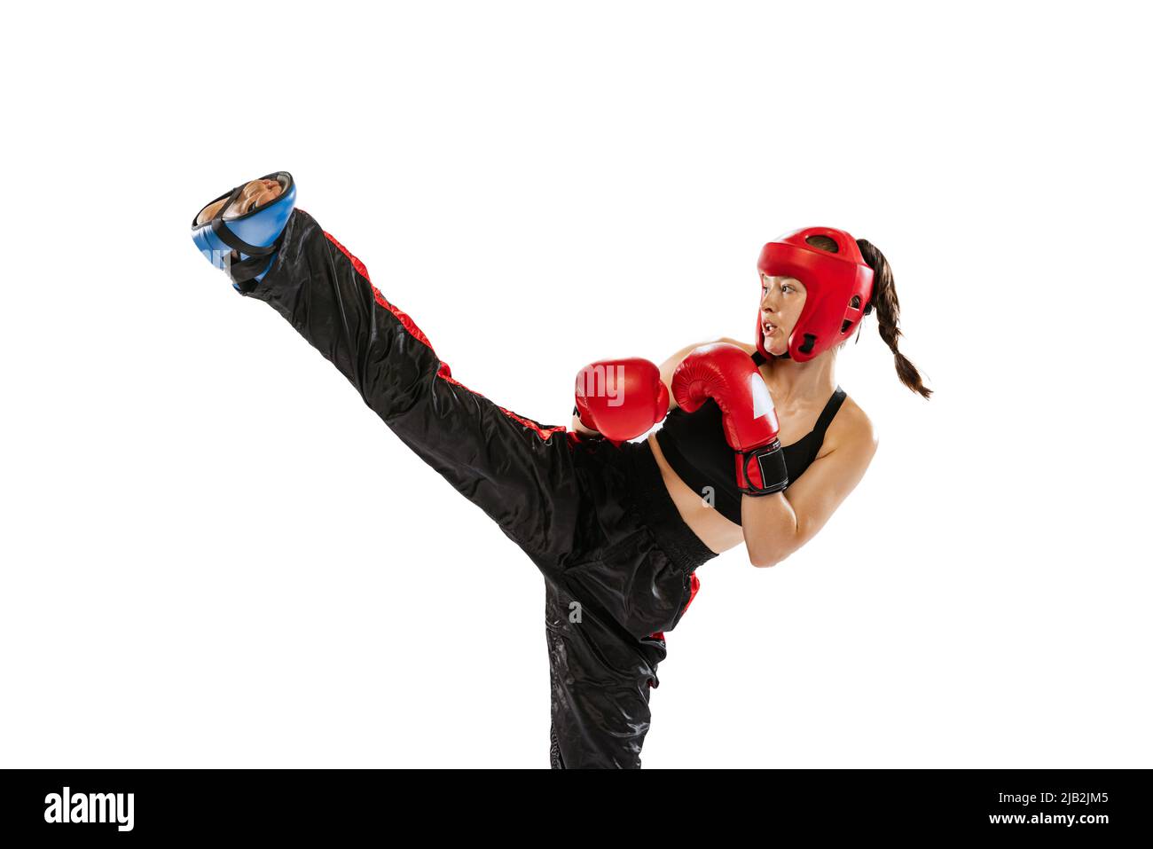 One female boxer in boxing gloves and helmet training isolated on white ...