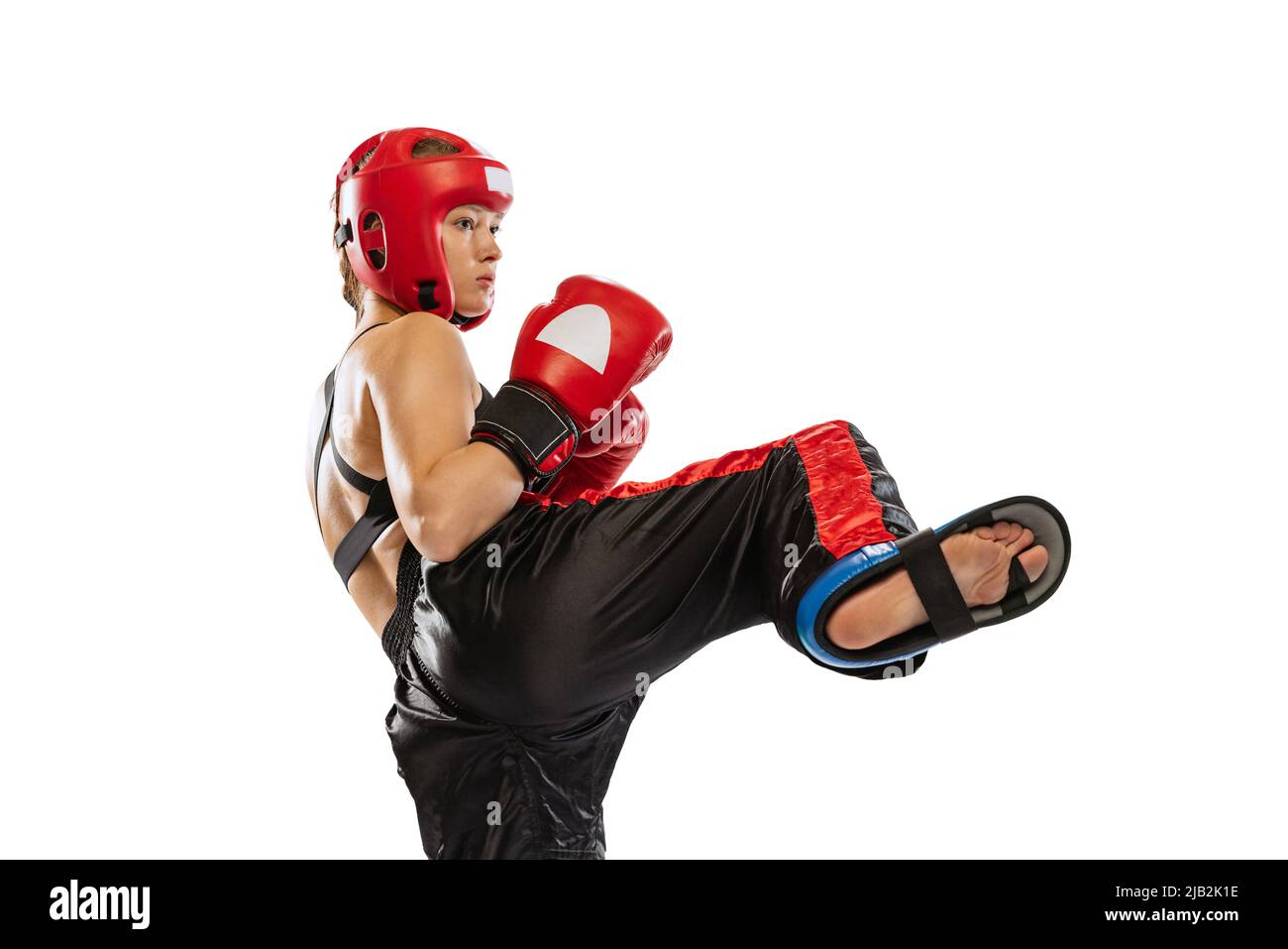 Close-up female boxer in boxing gloves and helmet training isolated on ...