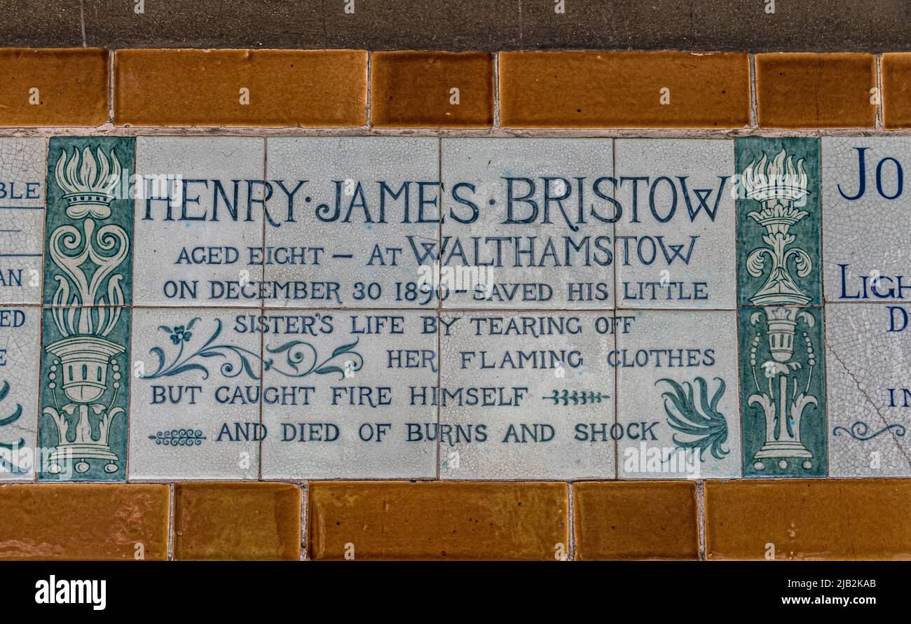 A ceramic memorial tablet dedicated to Henry James Bristow on the wall ...