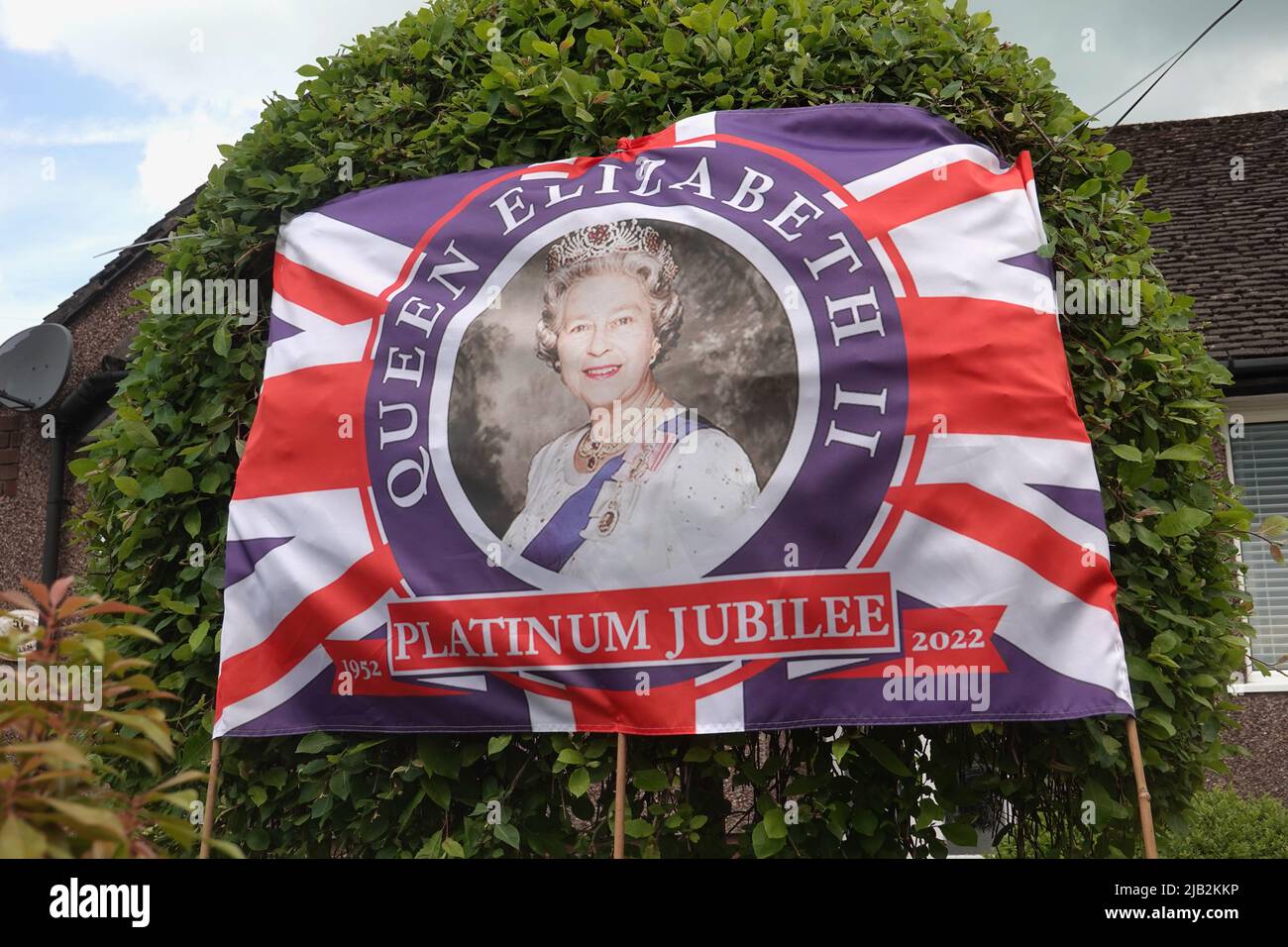 A decorated flag supporting the Queen's Platinum Jubilee in a front ...