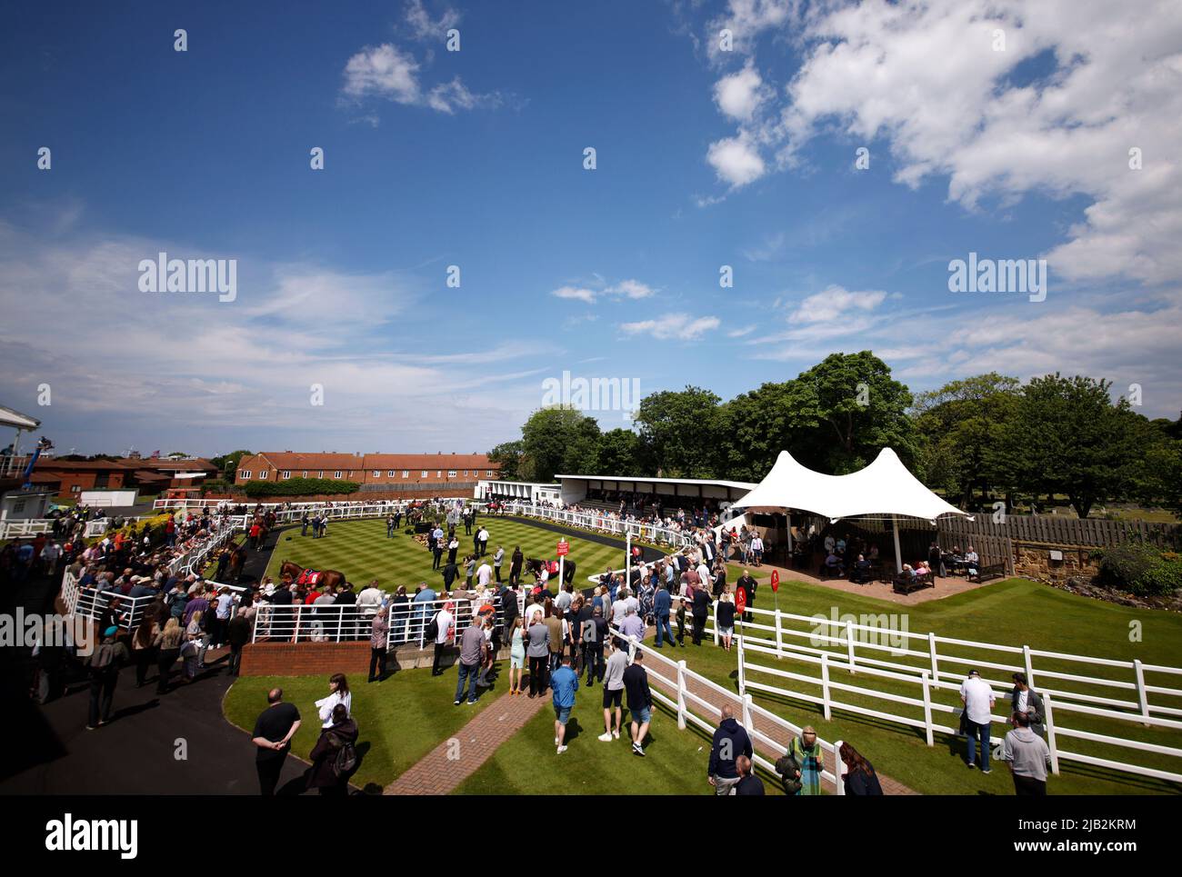 Racegoers by the parade ring at Redcar Racecourse. Picture date ...
